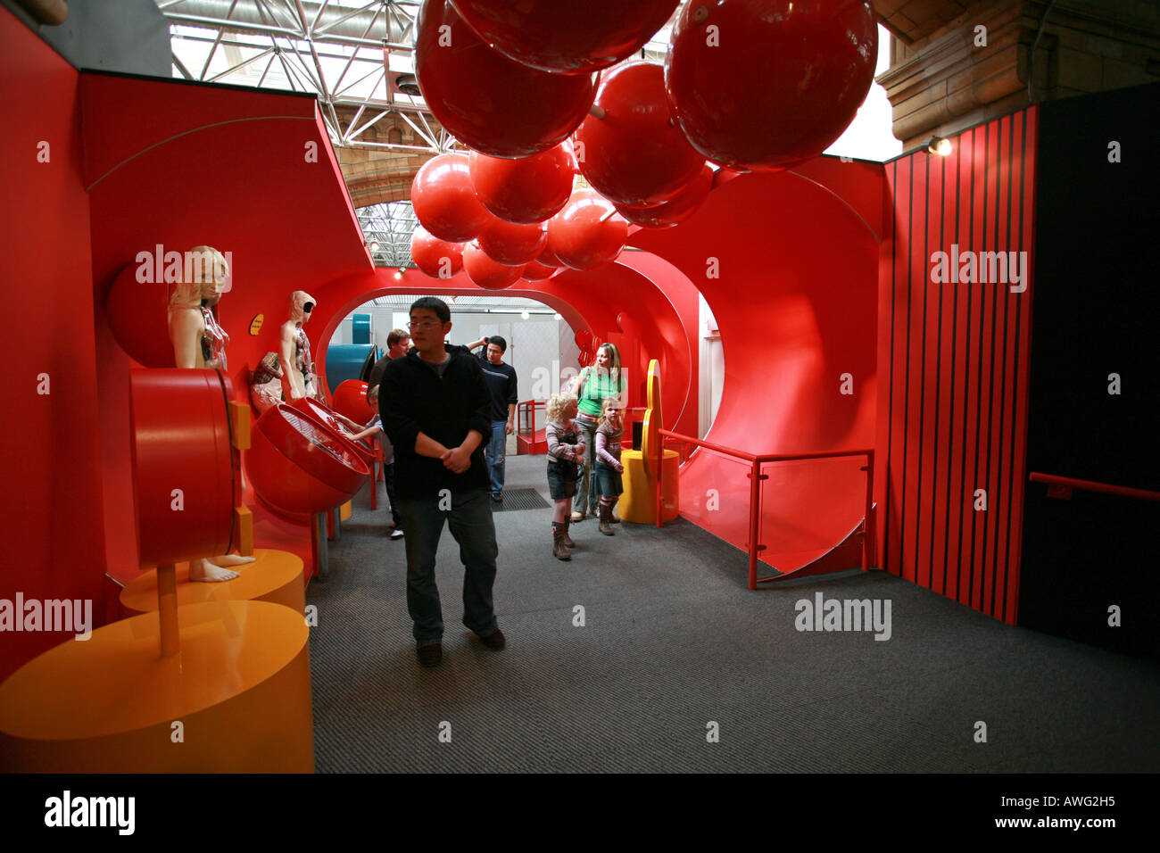 Tourists walk through an exhibit on red blood cells at the Natural ...