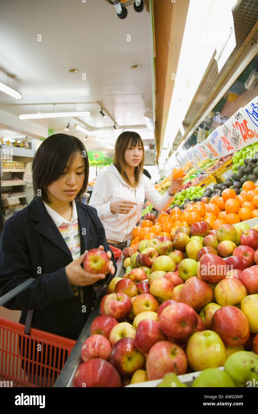 Two young women shopping in supermarket Stock Photo - Alamy