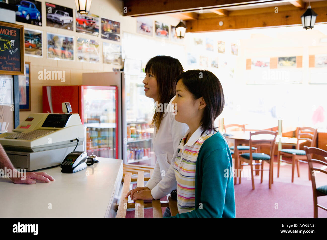 Two young women ordering food at fast food restaurant Stock Photo - Alamy