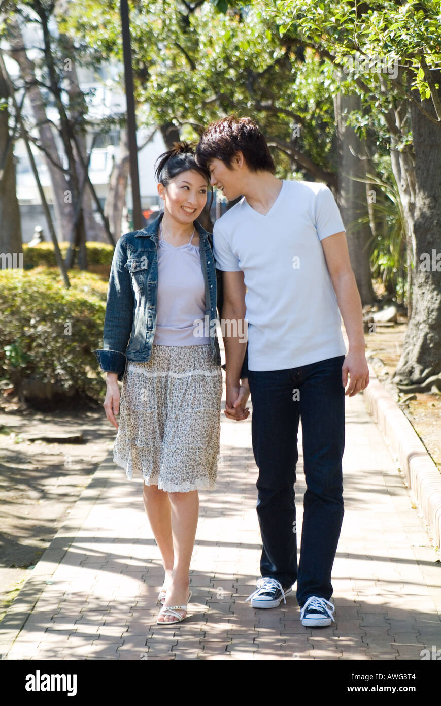Happy couple walking on tree hi-res stock photography and images - Alamy