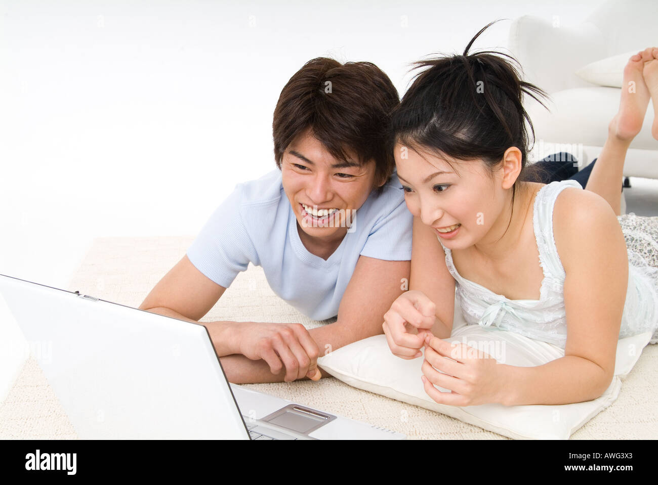 Young asian couple looking laptop hi-res stock photography and images ...