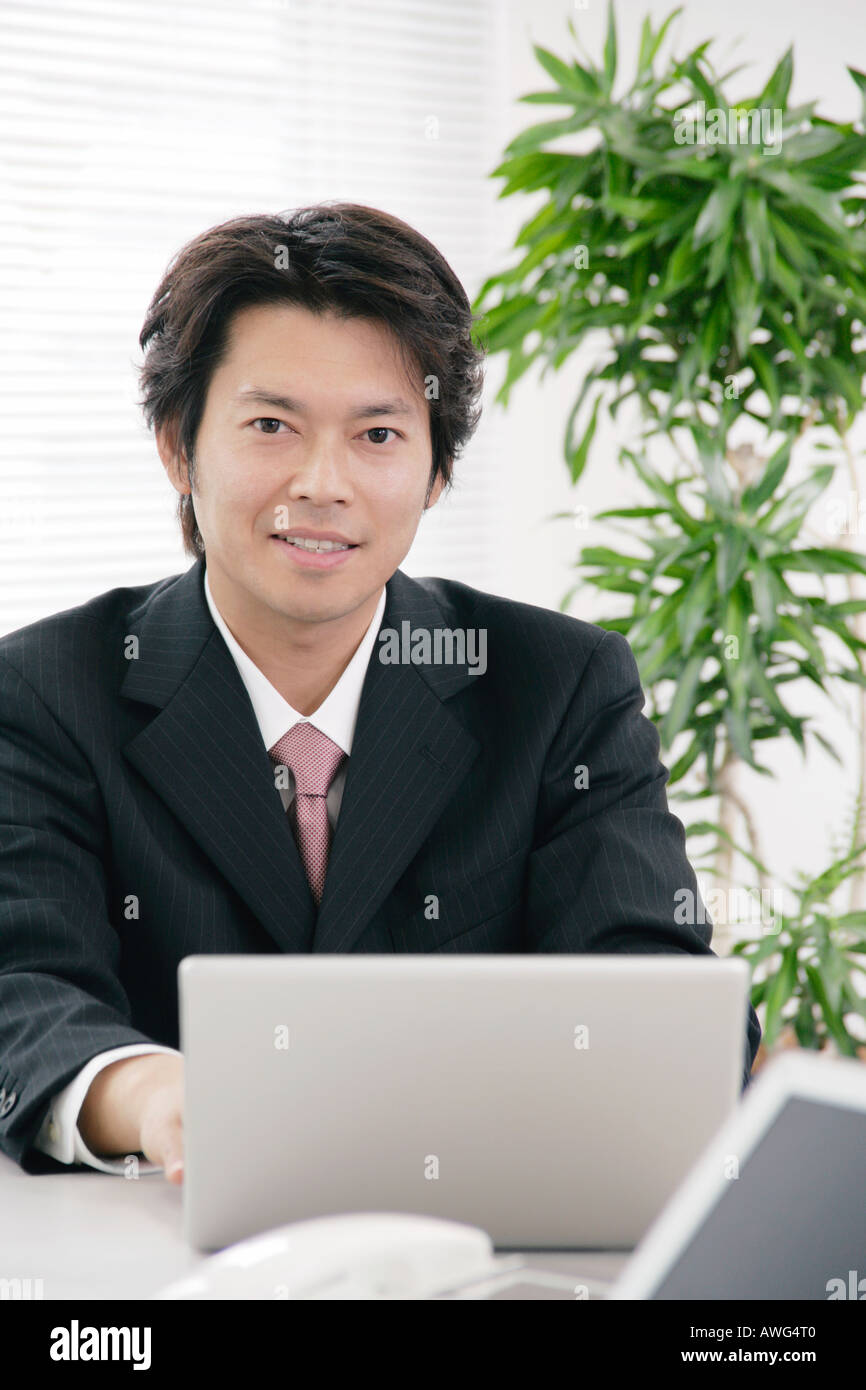 Mid adult man working in office Stock Photo - Alamy