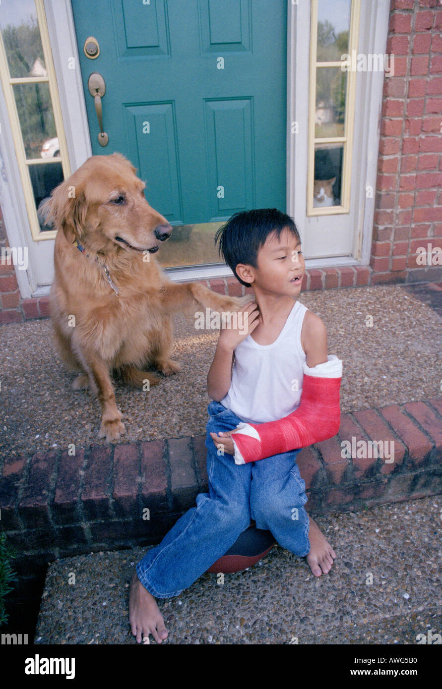 Asian boy with broken arm and his dog Stock Photo - Alamy