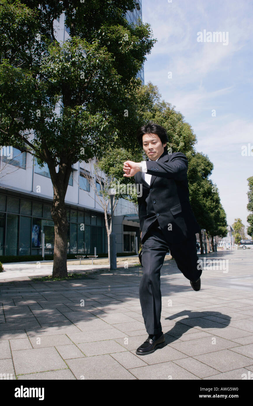 A mid adult businessman running Stock Photo - Alamy