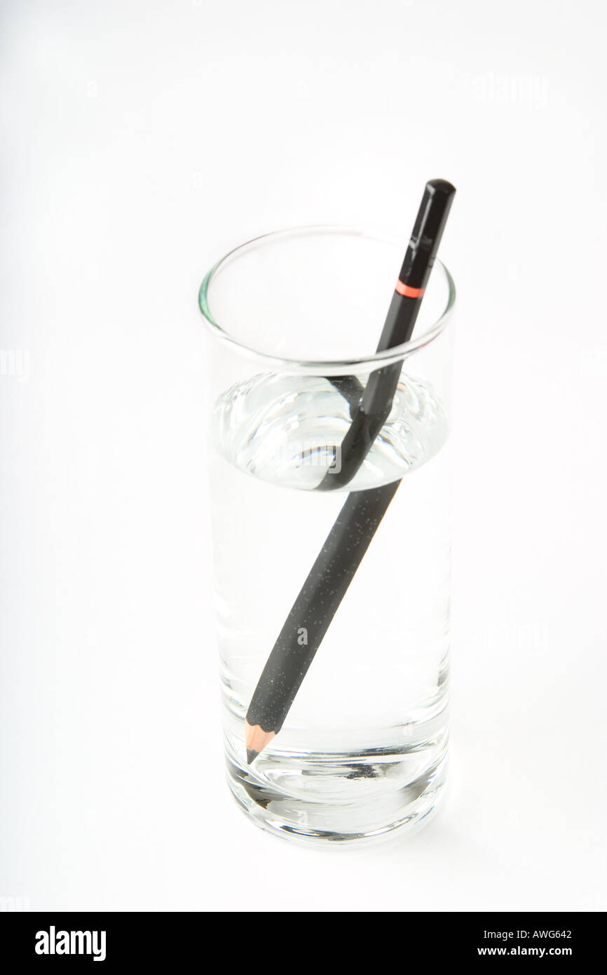 Pencil in a glass of water showing refraction effect Stock Photo - Alamy