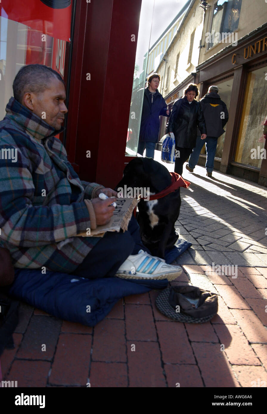 Man begging in street while people pass him by Stock Photo - Alamy