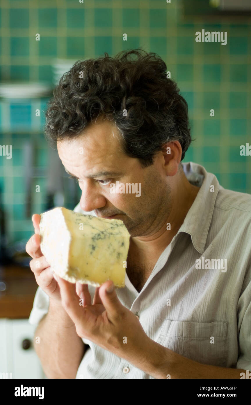 well known London chef Mark Hix in his own home kitchen smelling cheese ...