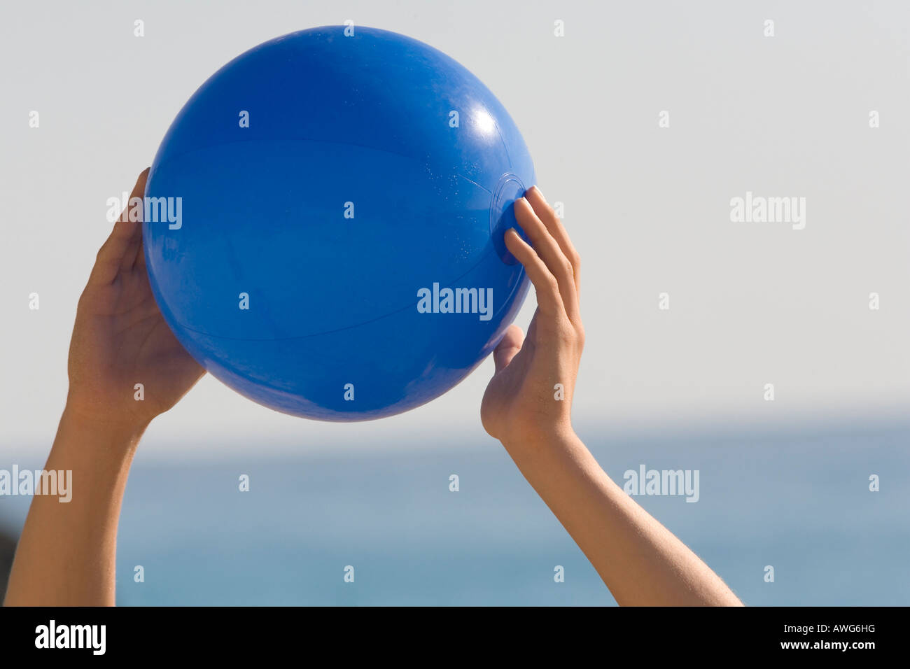 blue ball in the hands Stock Photo - Alamy
