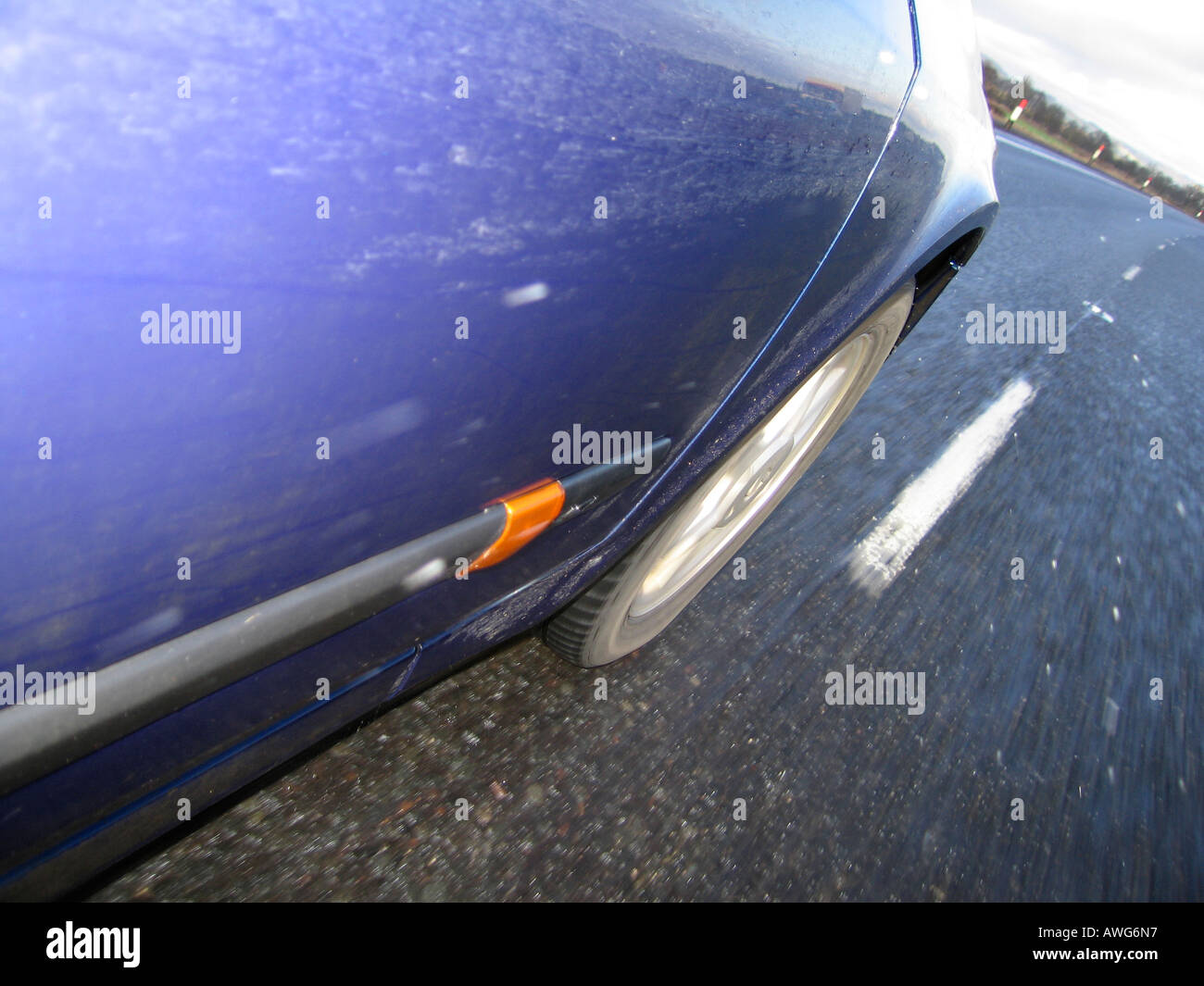 Spray from car wheel on wet road shot from car Stock Photo - Alamy