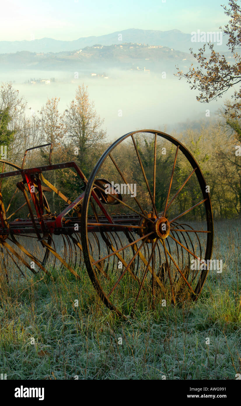 An old farm harvester rusts in the frost and through the mist emerges ...
