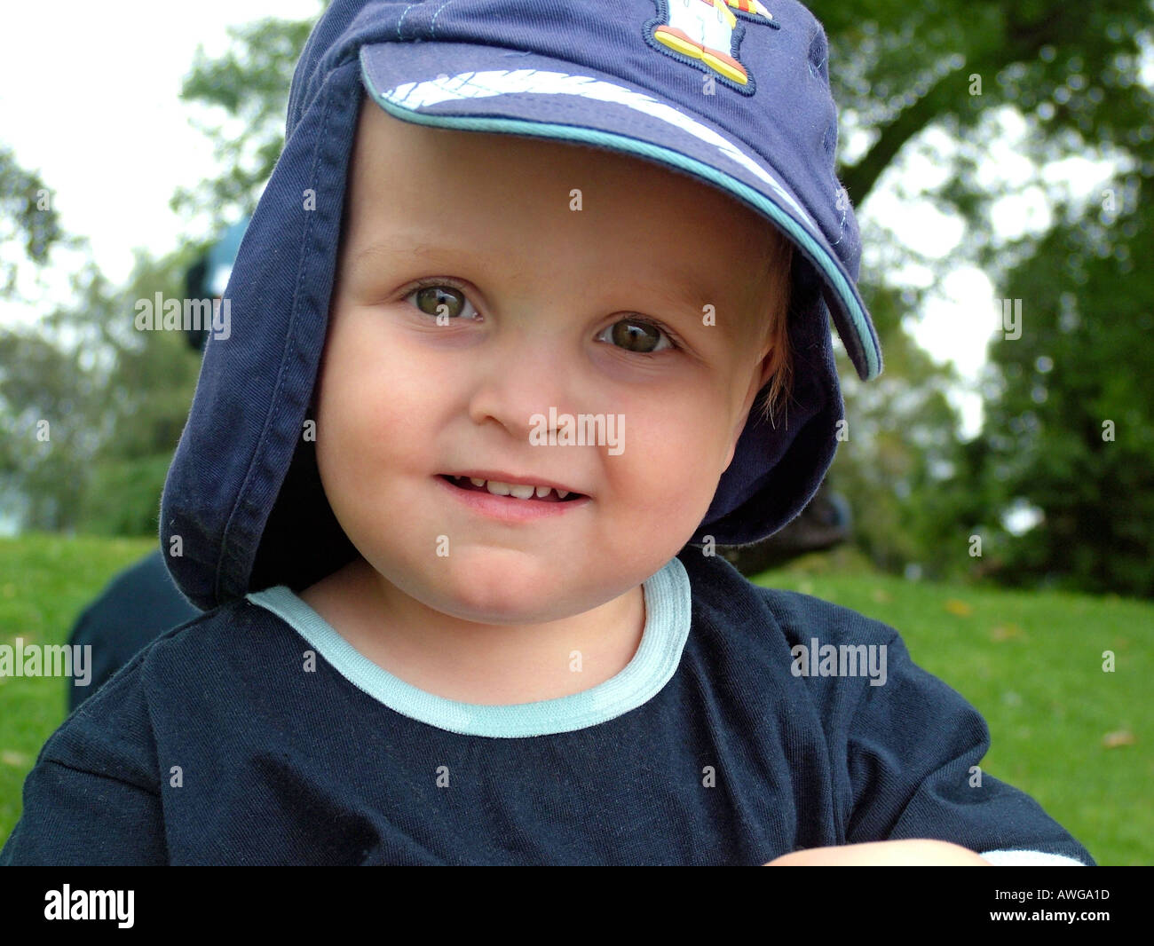 Young boy smiling wearing a cap Stock Photo - Alamy
