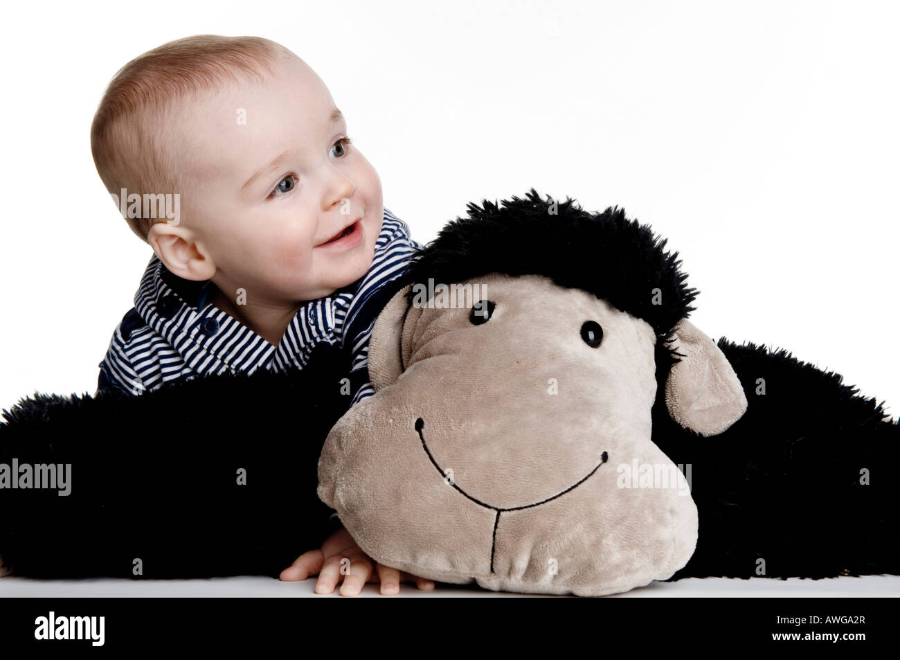 Smiling baby with soft toy Stock Photo - Alamy