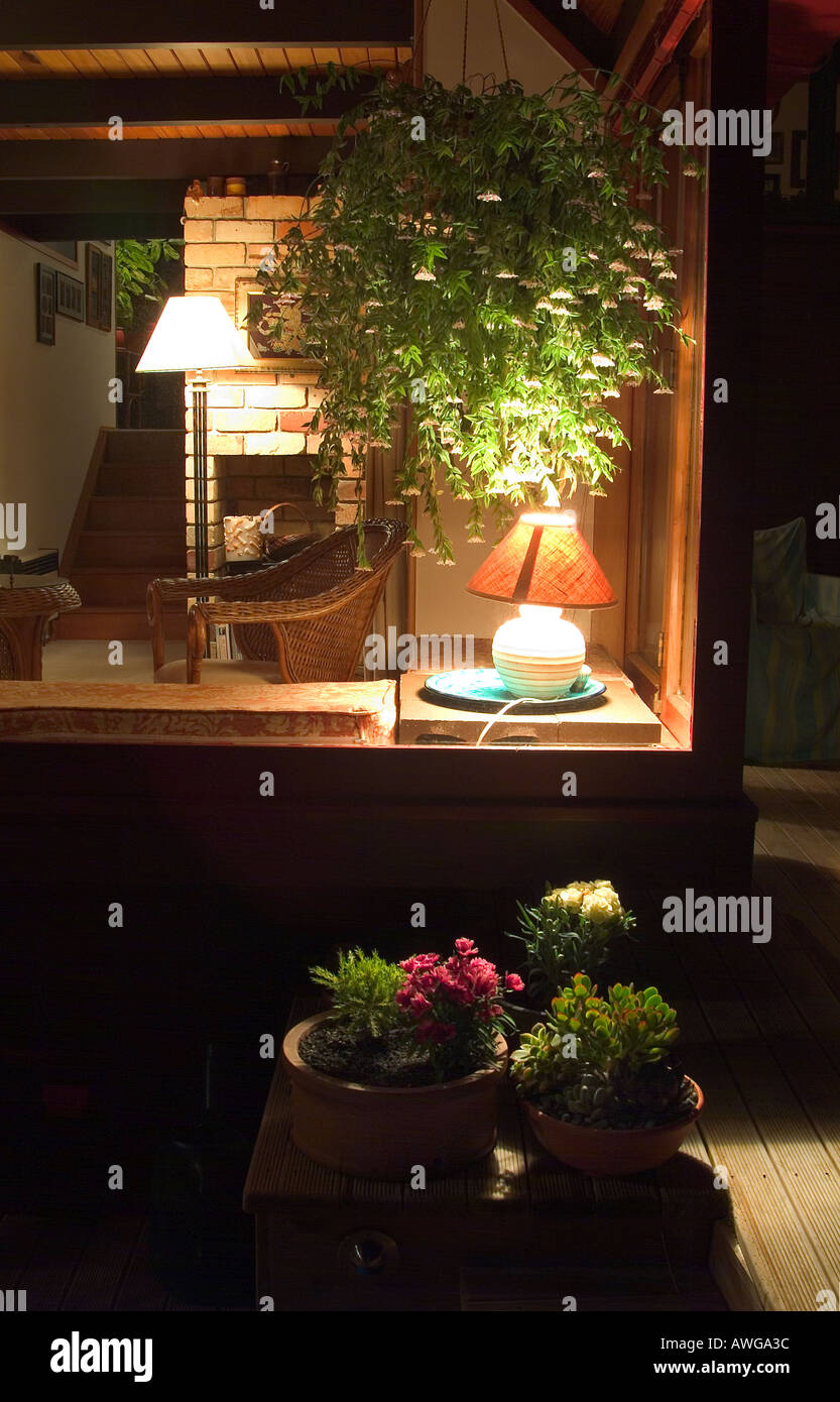 Lights shining through the window of a house at night Stock Photo - Alamy