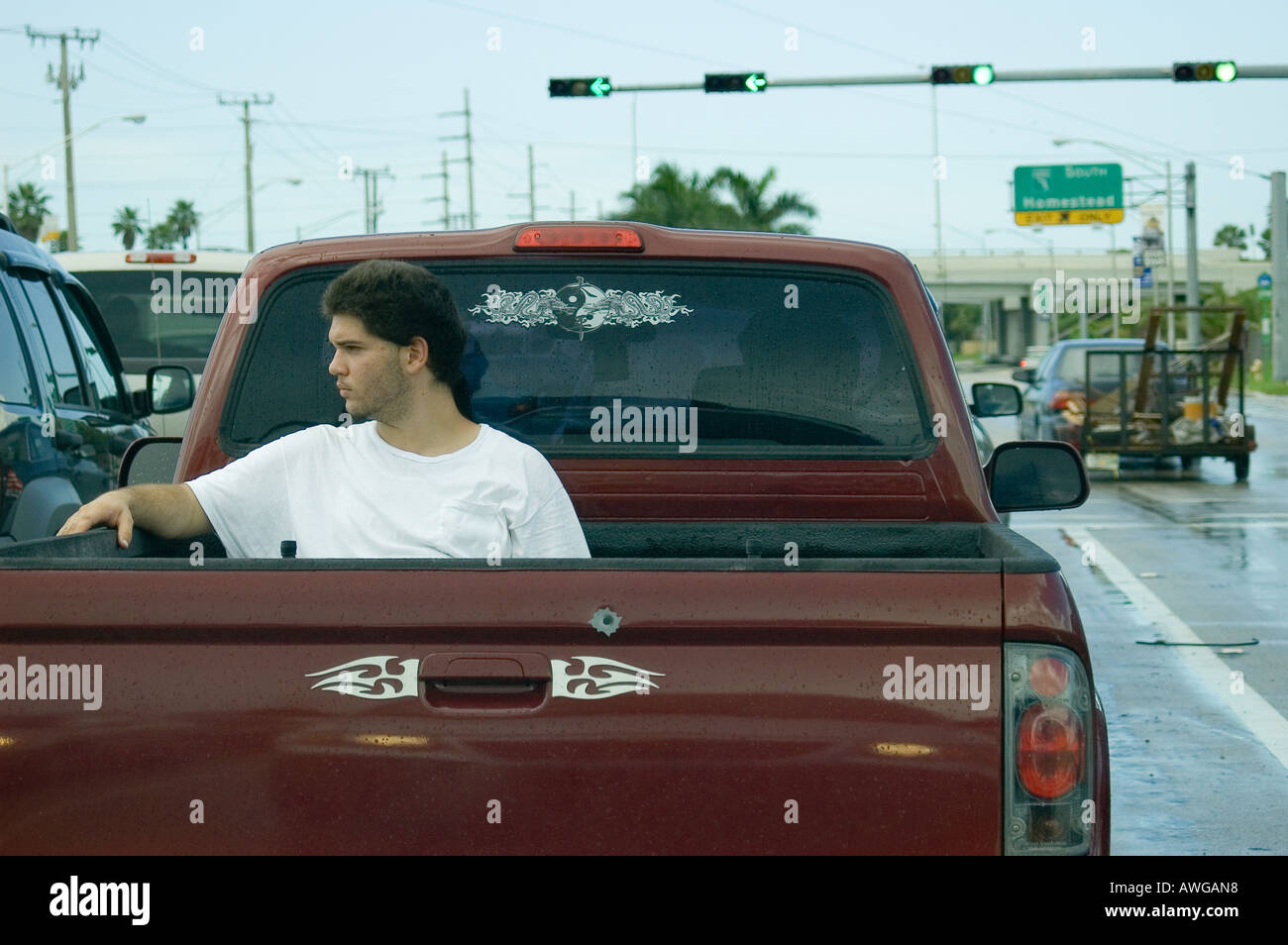 Young man on the back of a truck Stock Photo - Alamy