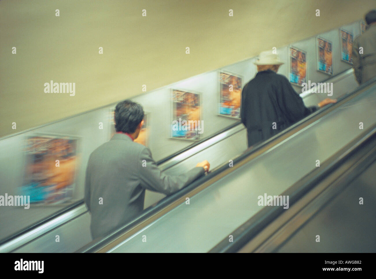 Men standing on an escalator London UK Stock Photo - Alamy