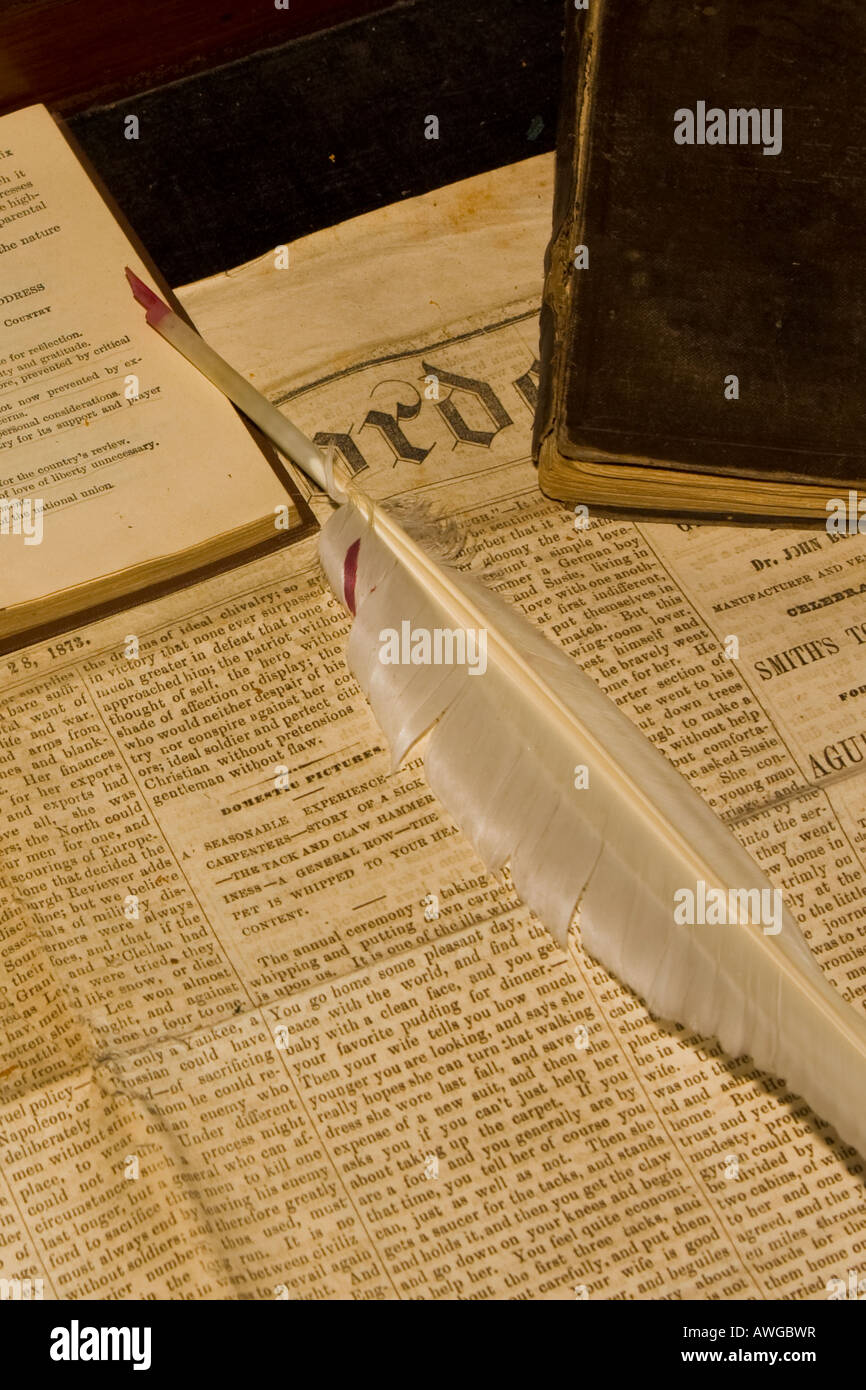 Antique Newspaper with Feather and Books Stock Photo - Alamy