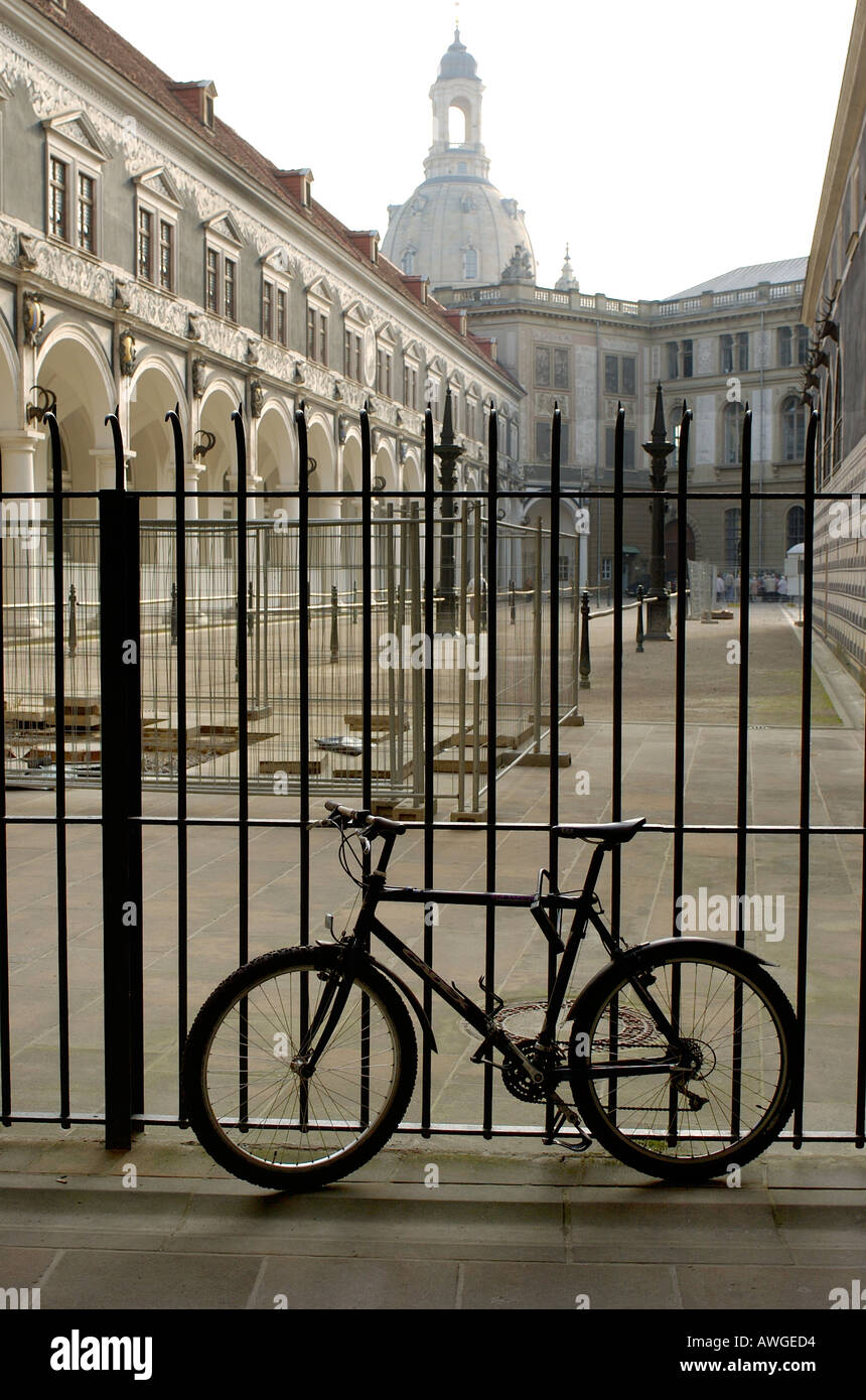 Bicycle by fence Stock Photo - Alamy
