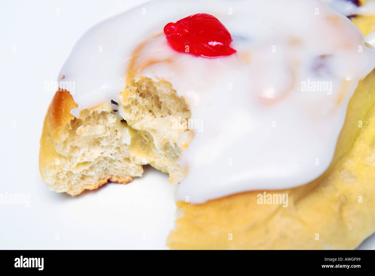 Belgian pastry bun icing and cherry Stock Photo - Alamy