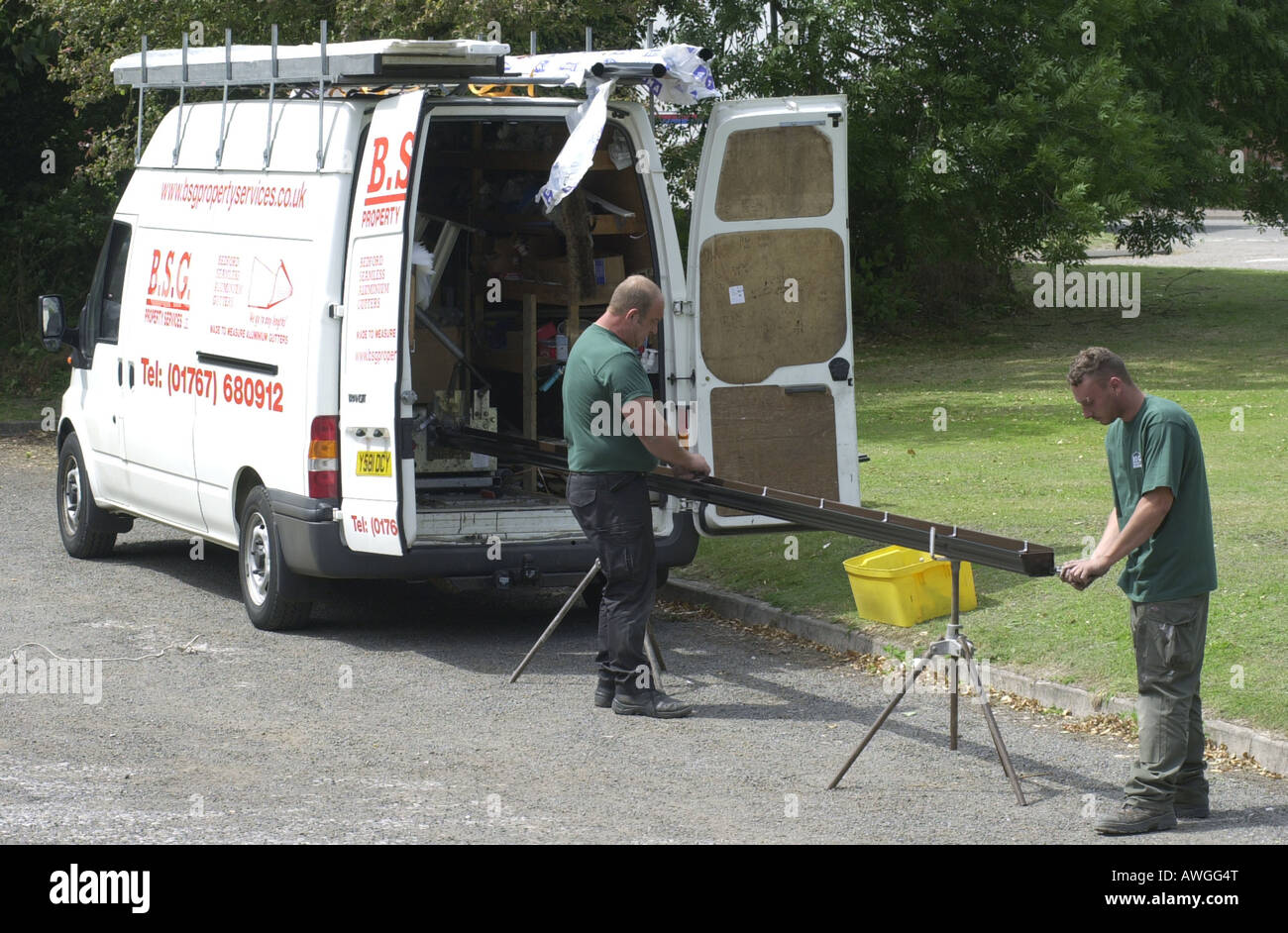 Black continuous preformed gutter being made in the street UK Stock ...