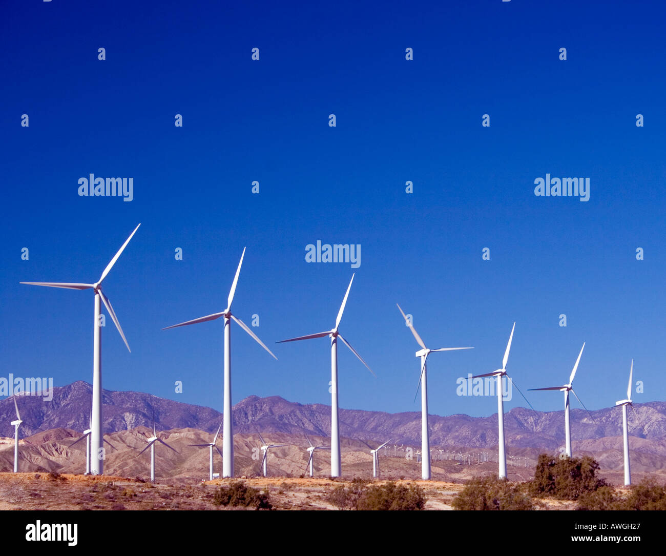 Wind turbines spin across the desert landscape near Palm Springs ...