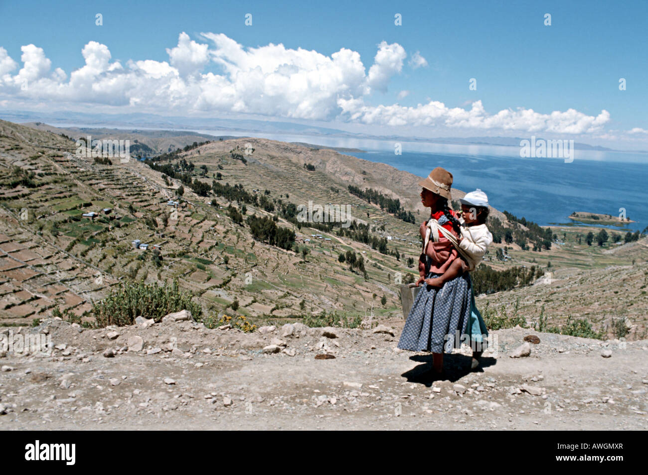 Bolivia Native aymara woman and child walking in the Lake Titicaca ...