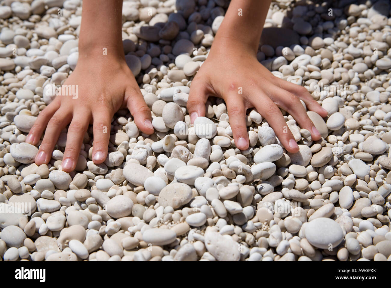 hands in the pebbles of the beach Stock Photo - Alamy