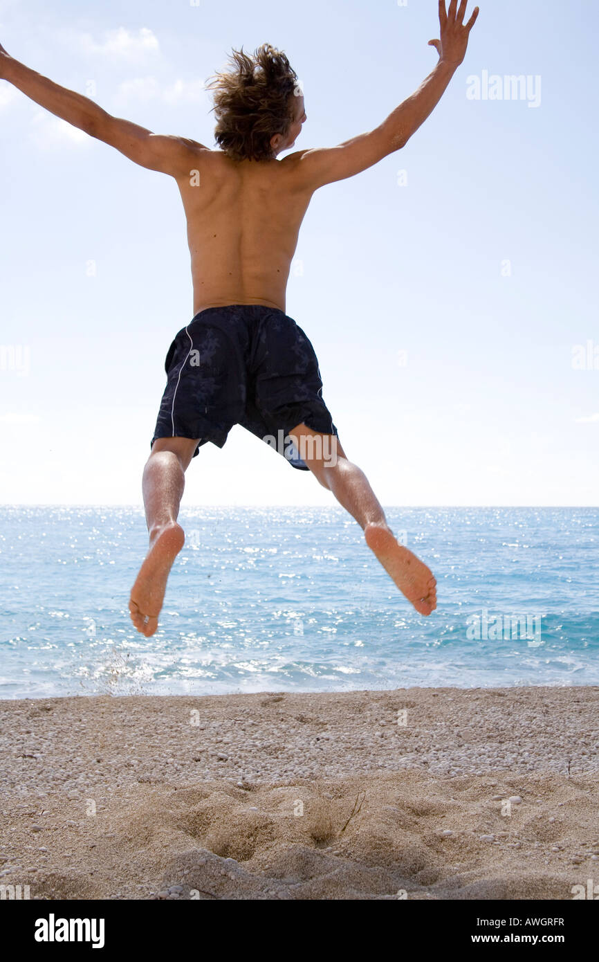 boy is jumping at the beach Stock Photo - Alamy