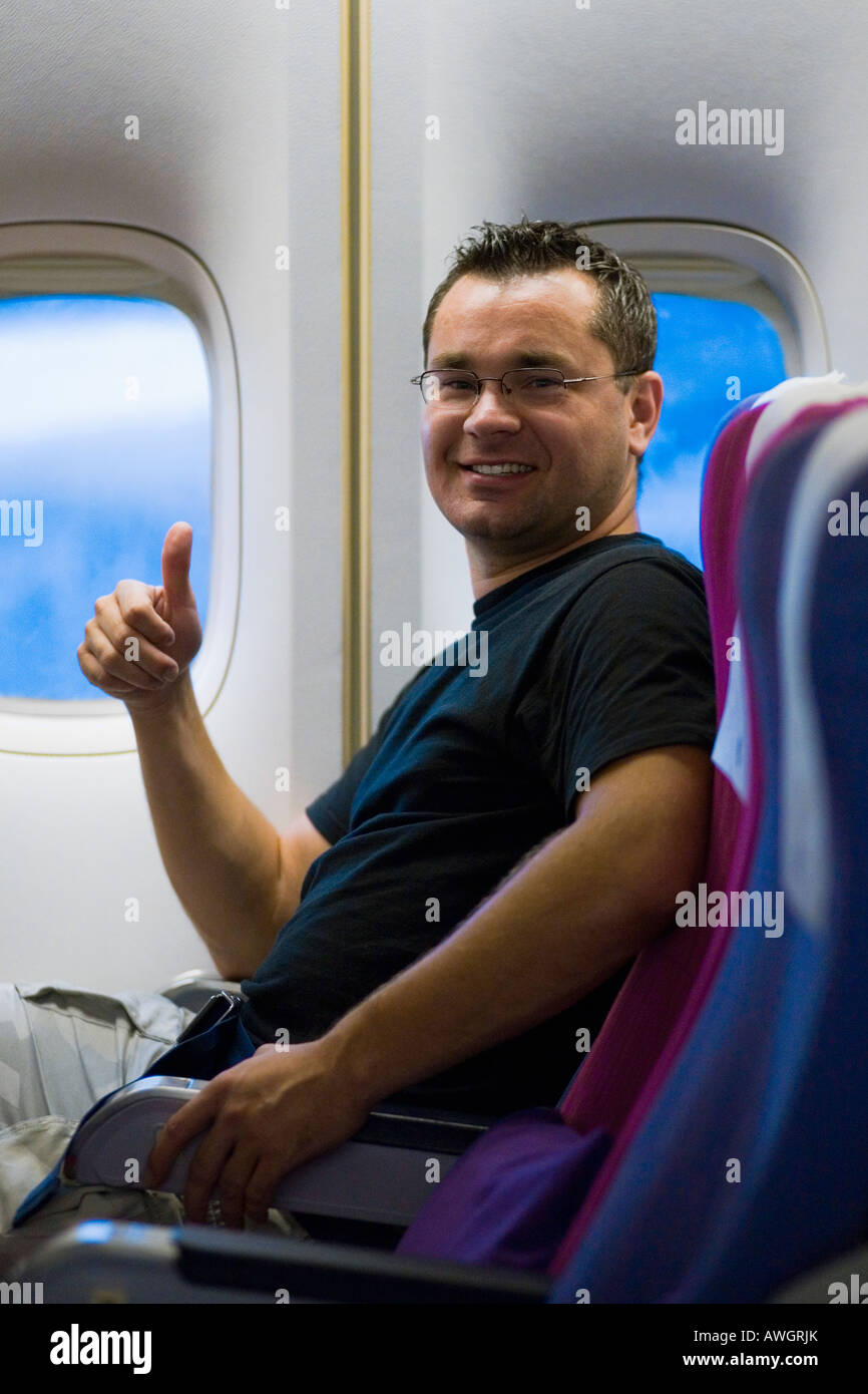 Young adult smiling airplane hi-res stock photography and images - Alamy
