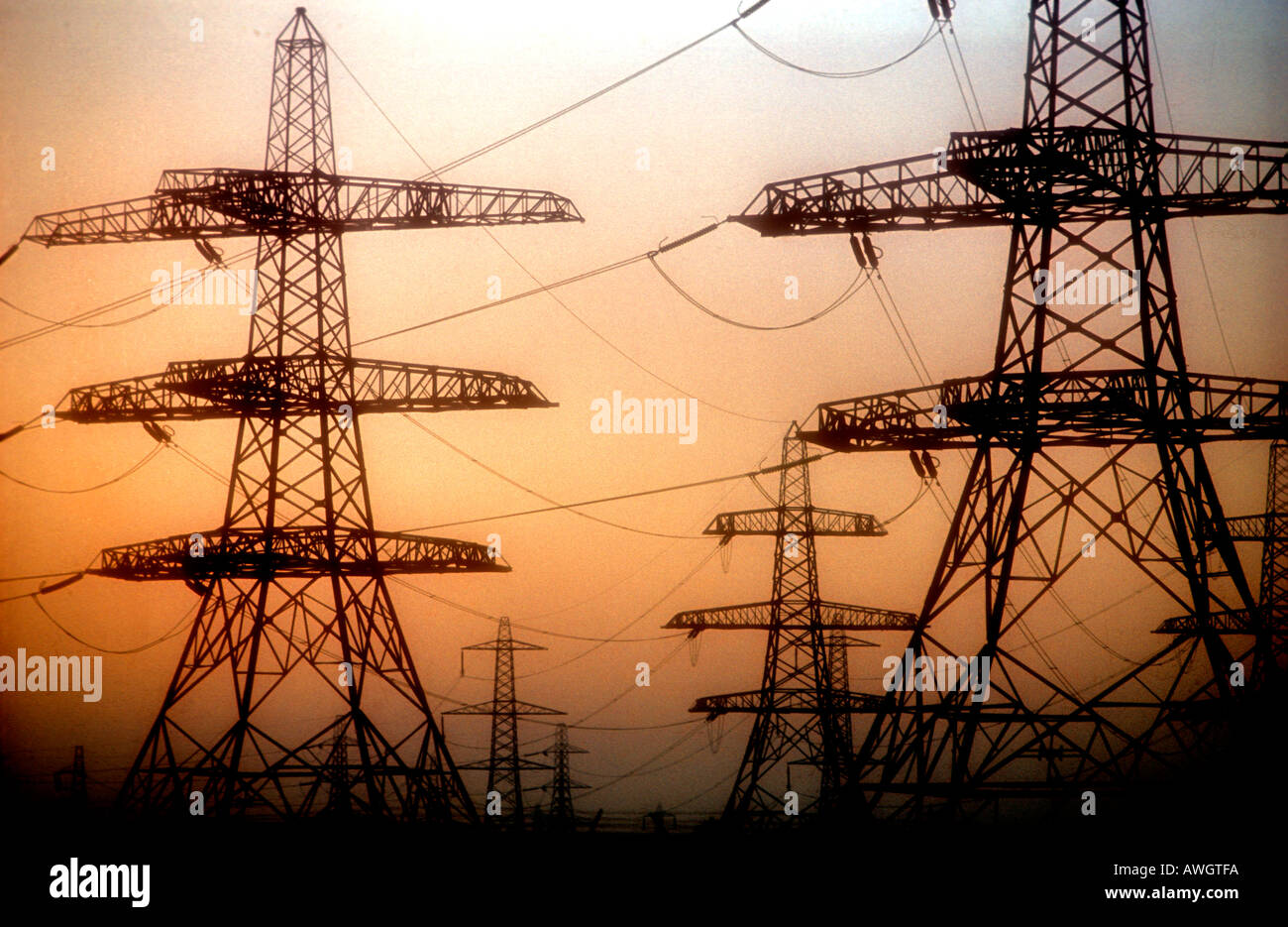 Electricity pylons silhouetted at dusk Dungeness Kent England UK Stock ...