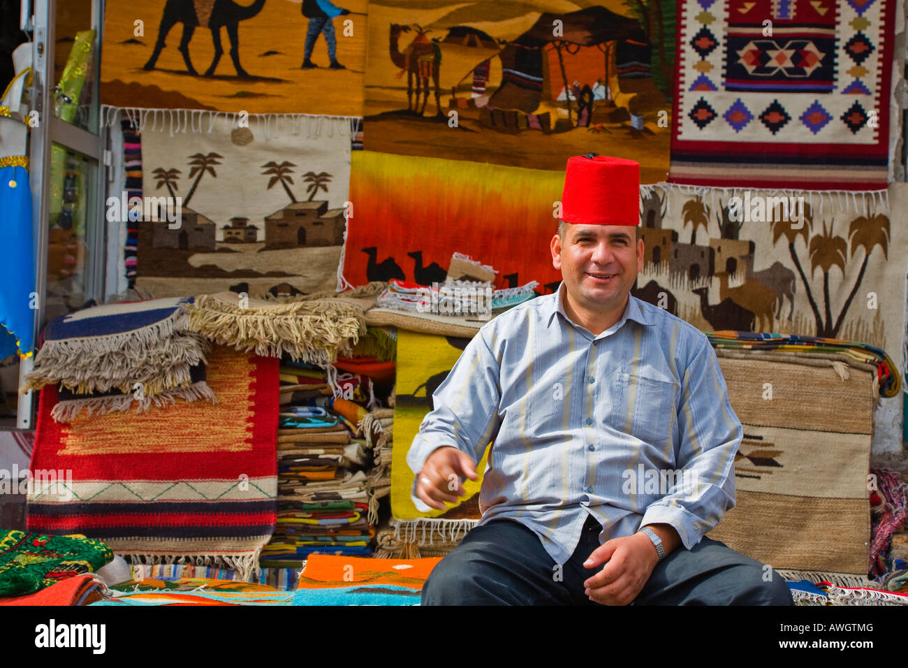 Egyptian man selling carpets in souk in Old Sharm Sinai Egypt Stock ...