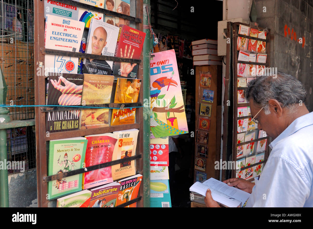 Mauritius island Mauritian man reading a book at kiosk Stock Photo - Alamy