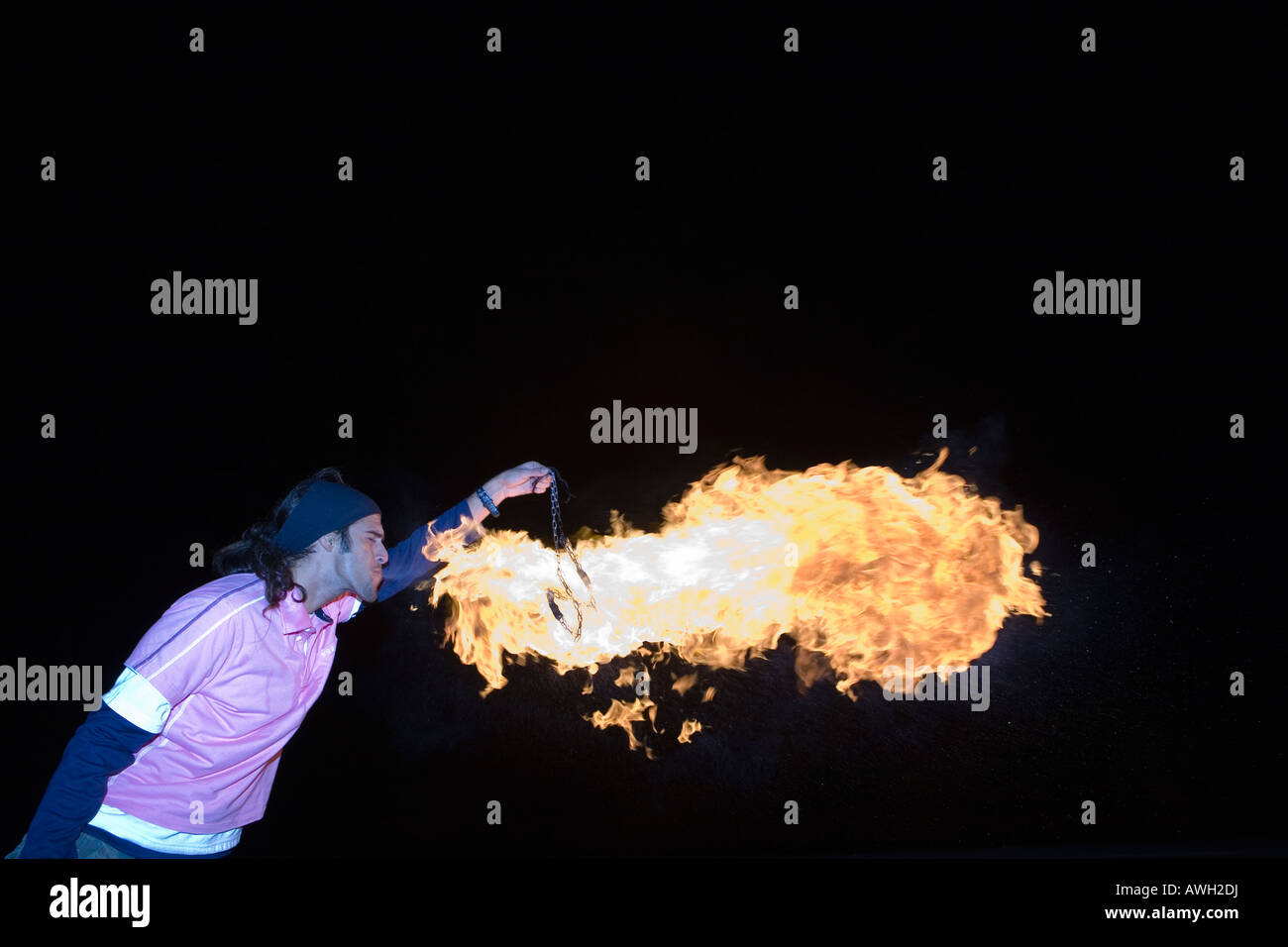 Man blowing flames out of his mouth at night Stock Photo - Alamy