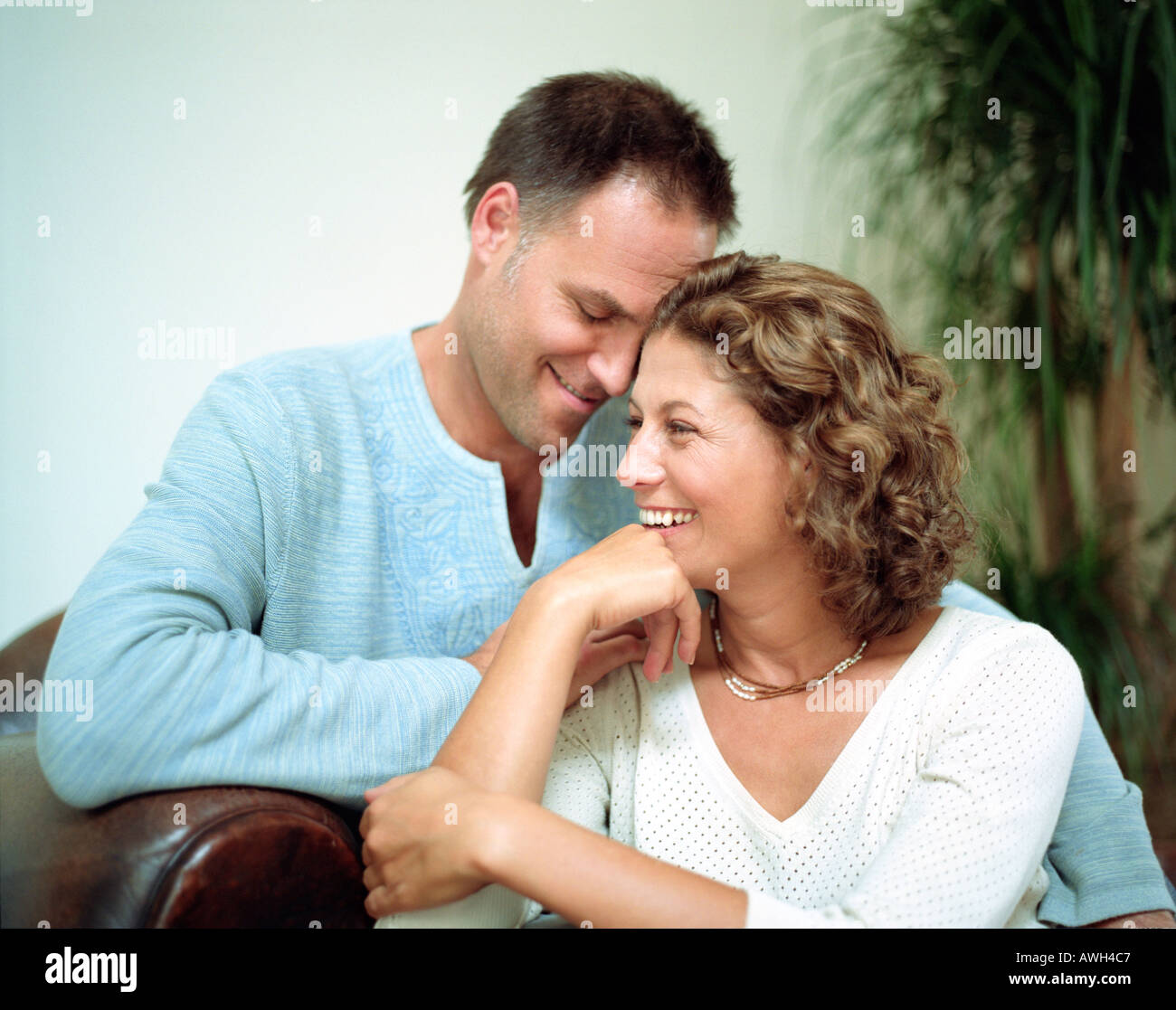 Happy white couple sitting hi-res stock photography and images - Alamy