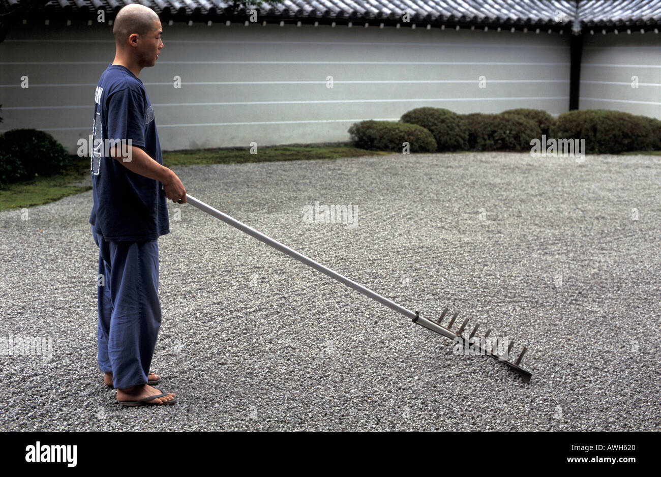 Buddhist monk raking the Zen garden of Nanzen ji Temple Kyoto Japan ...