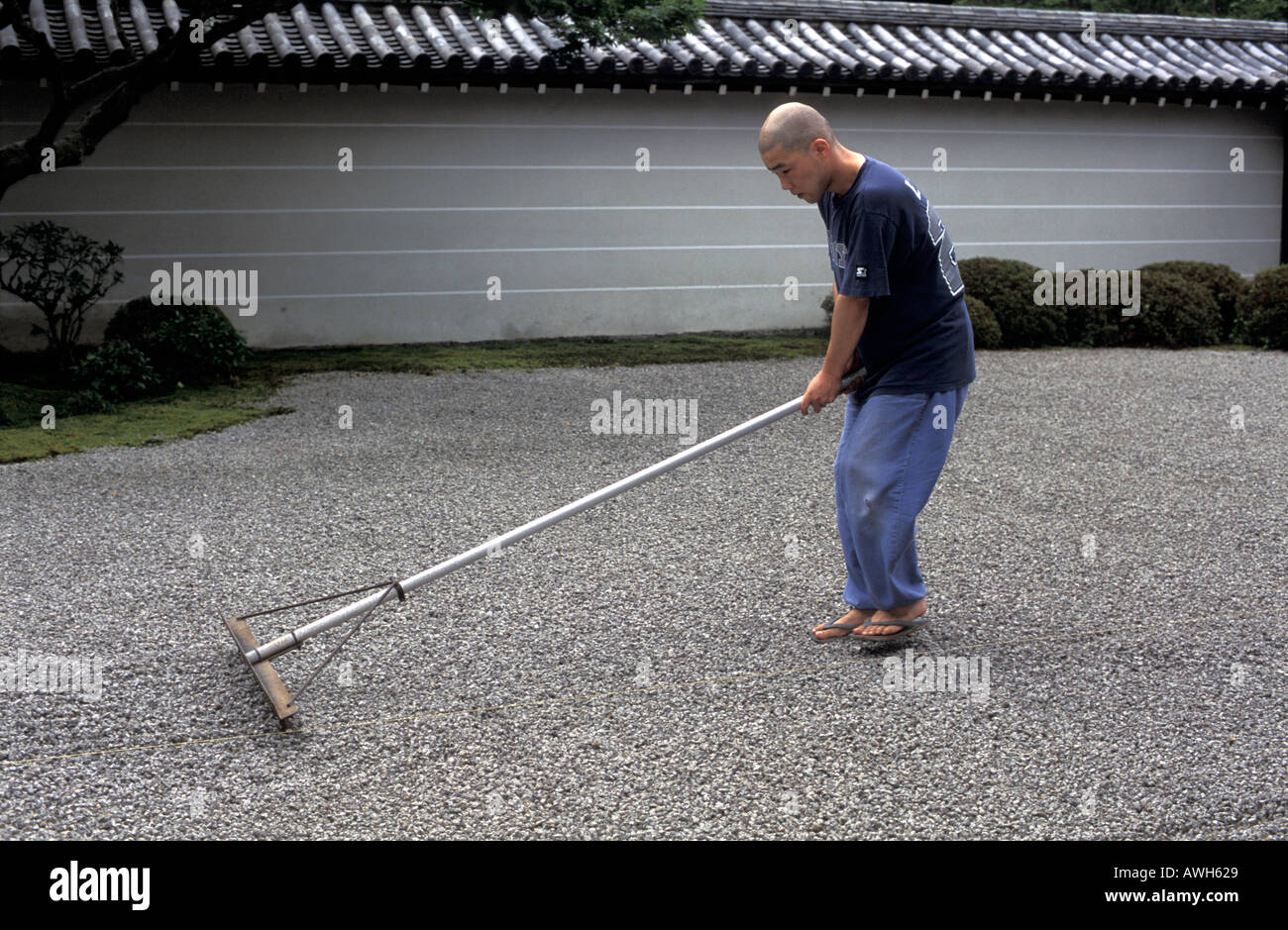 Buddhist monk raking the Zen garden of Nanzen ji Temple Kyoto Japan ...