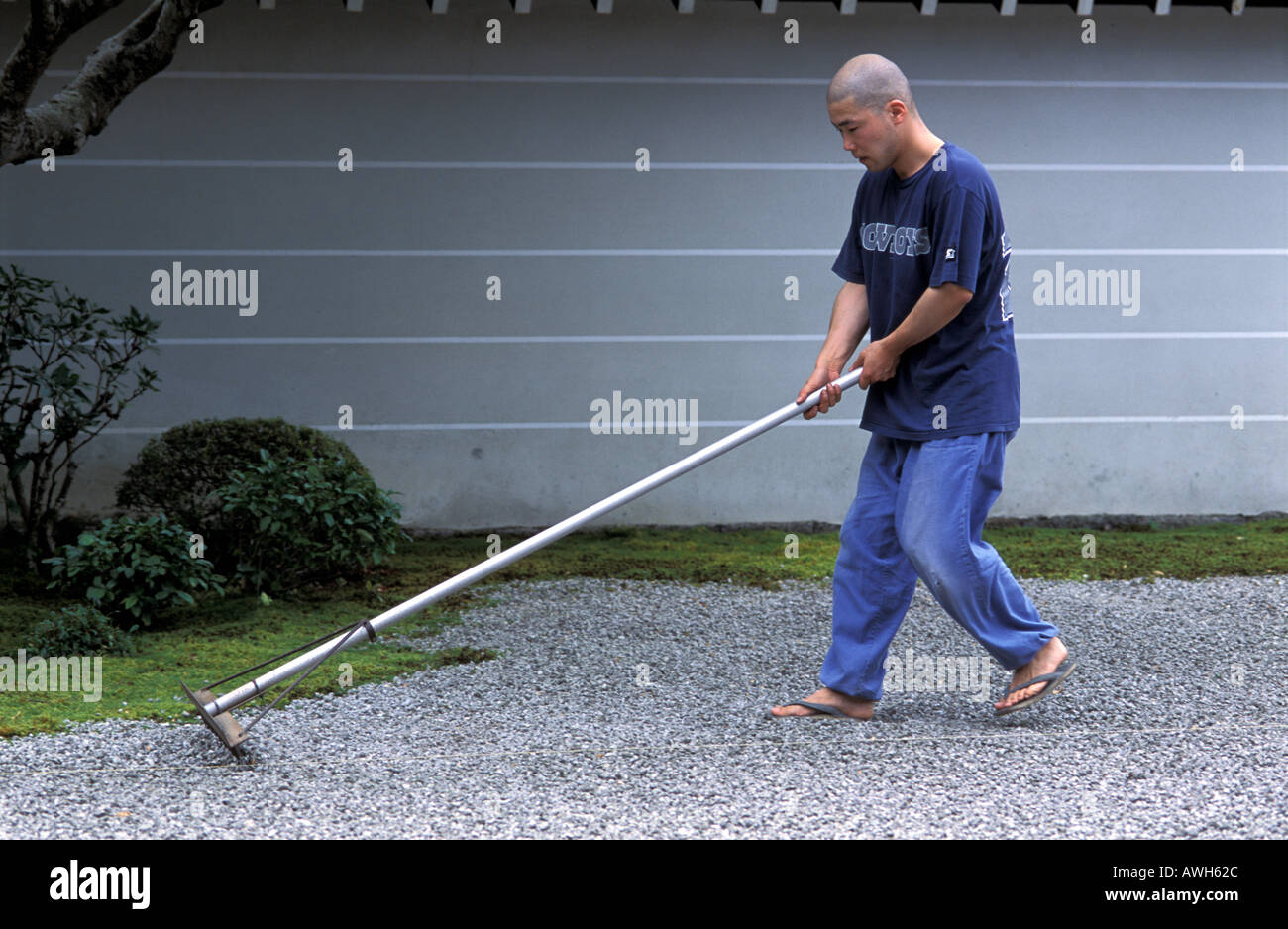 Buddhist monk raking the Zen garden of Nanzen ji Temple Kyoto Japan ...