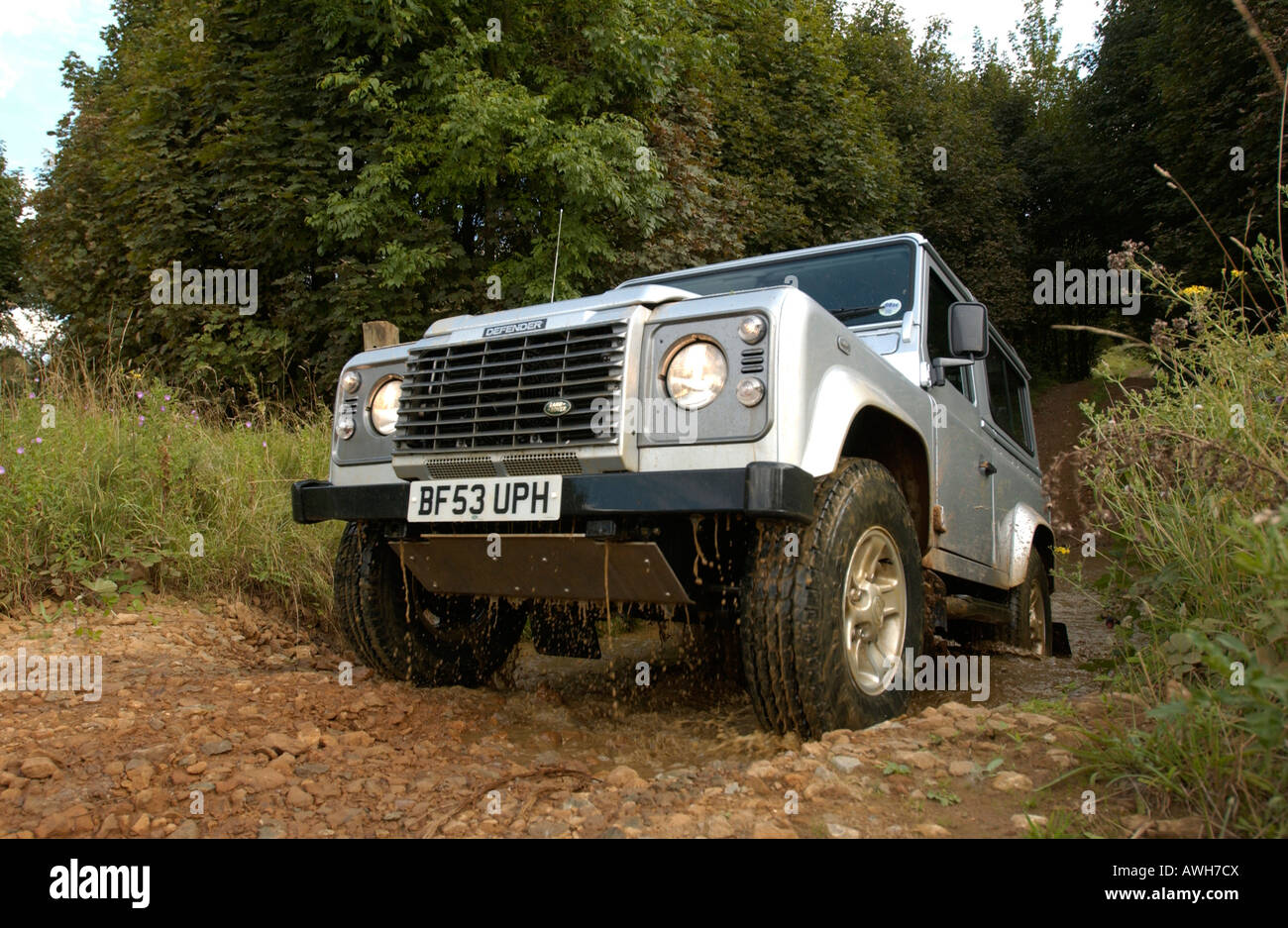 Land rover defender negotiating water hi-res stock photography and ...