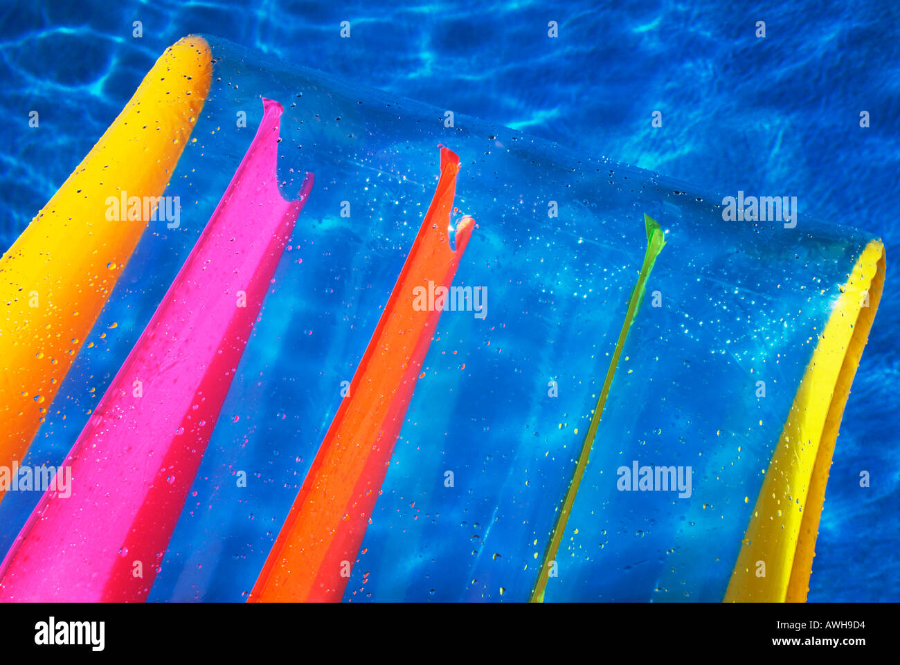Colourful lilo in swimming pool Stock Photo - Alamy