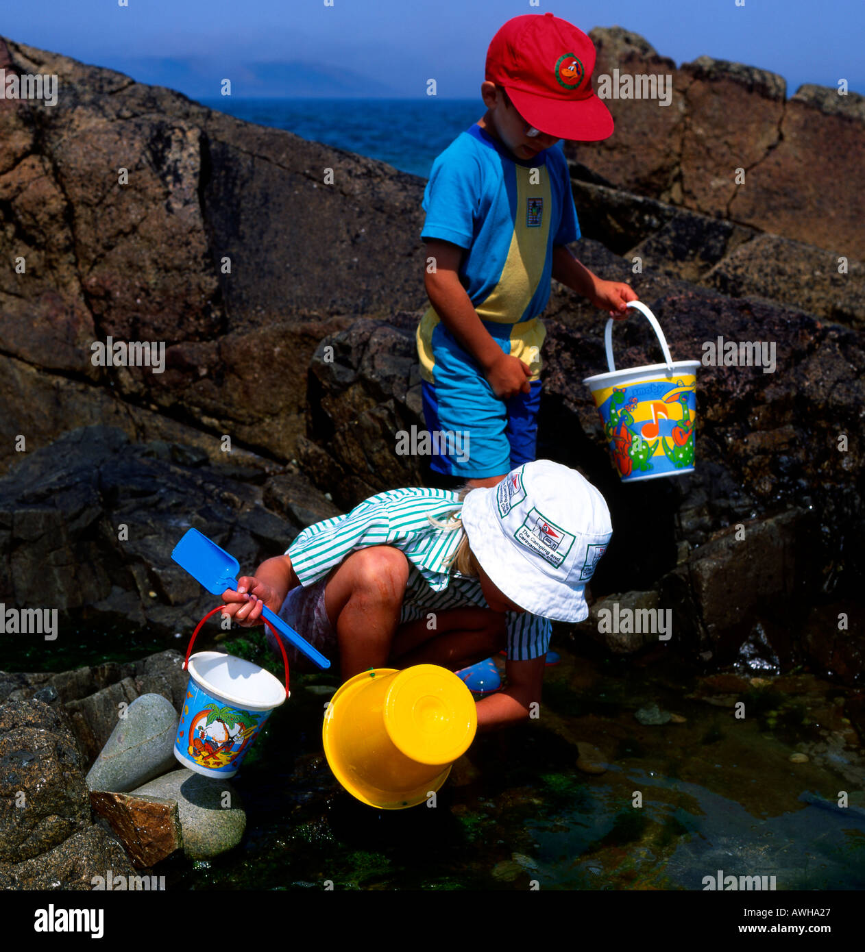 Children playing in Rock Pools at Port L Epine Brittany France Stock ...