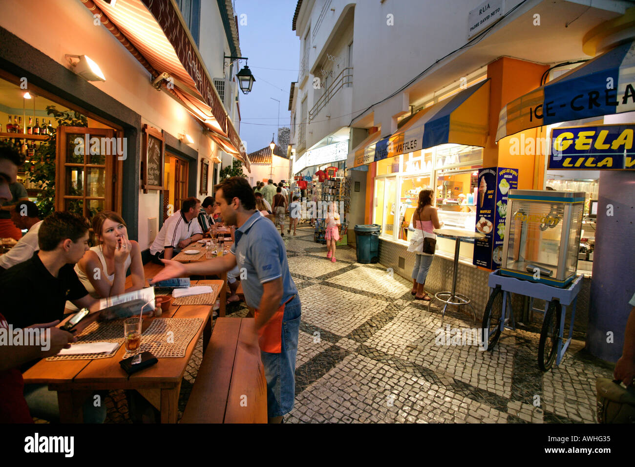 A typical evening street scene in Alvor on Portugal s Algarve coast ...