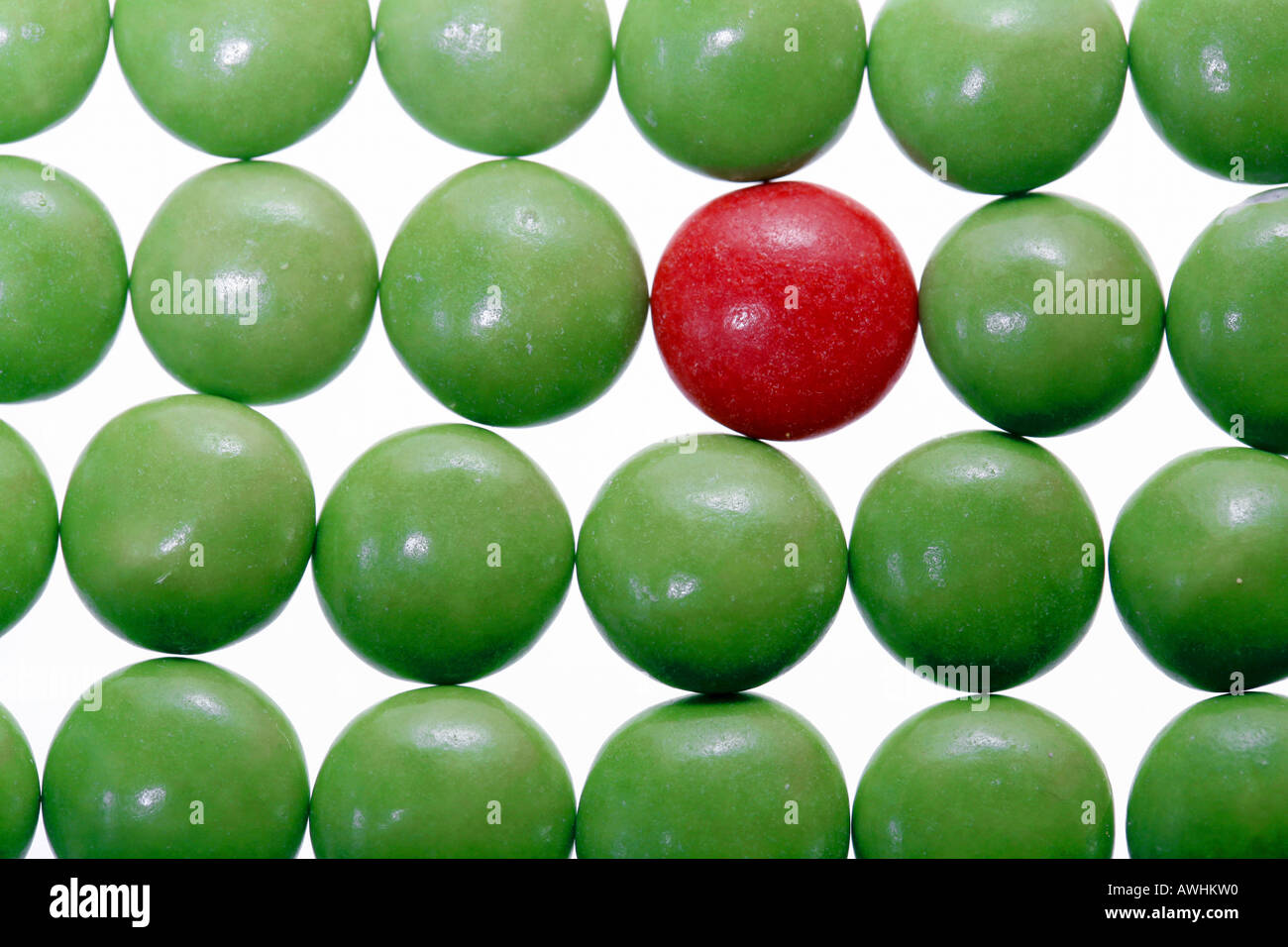 Sugar covered chocolates single red sweet amongst green sweets Stock ...