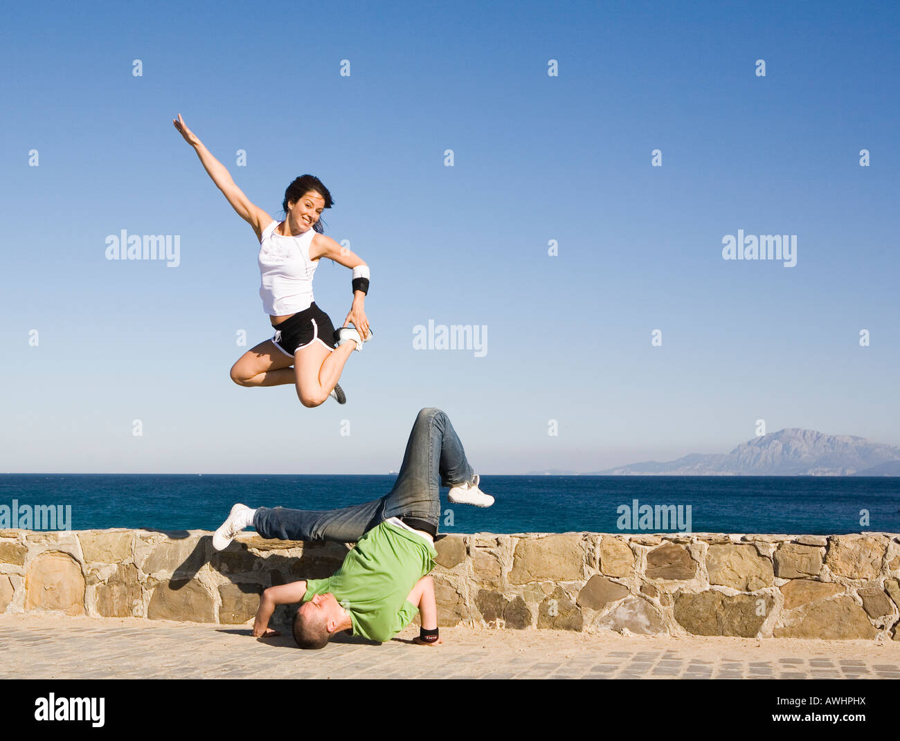 Young woman jumping over man hi-res stock photography and images - Alamy