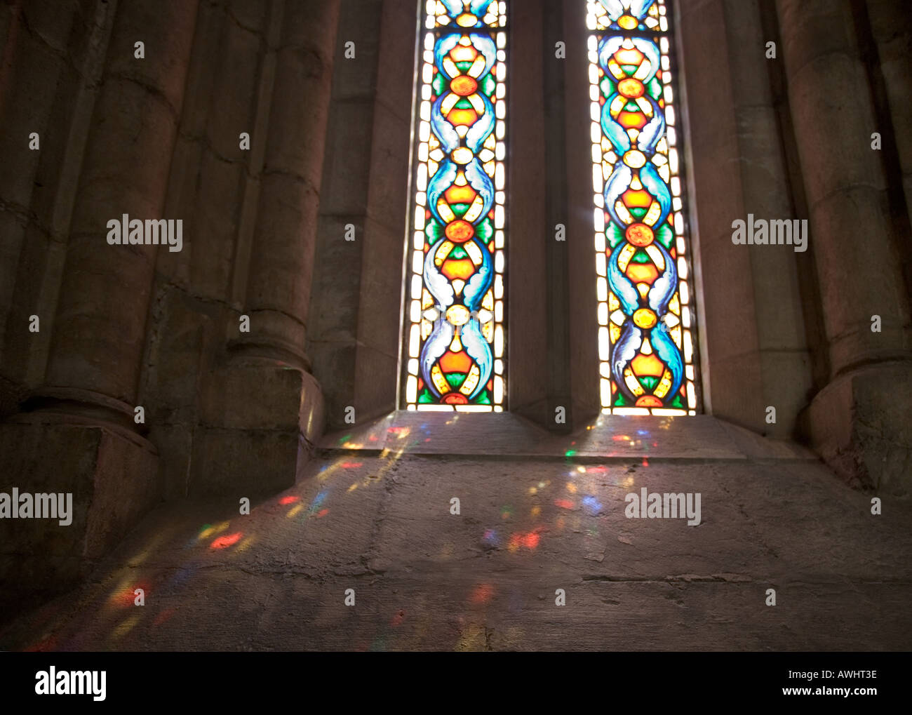 Sun pours through a stained glass window in the cathedral in Lisbon ...