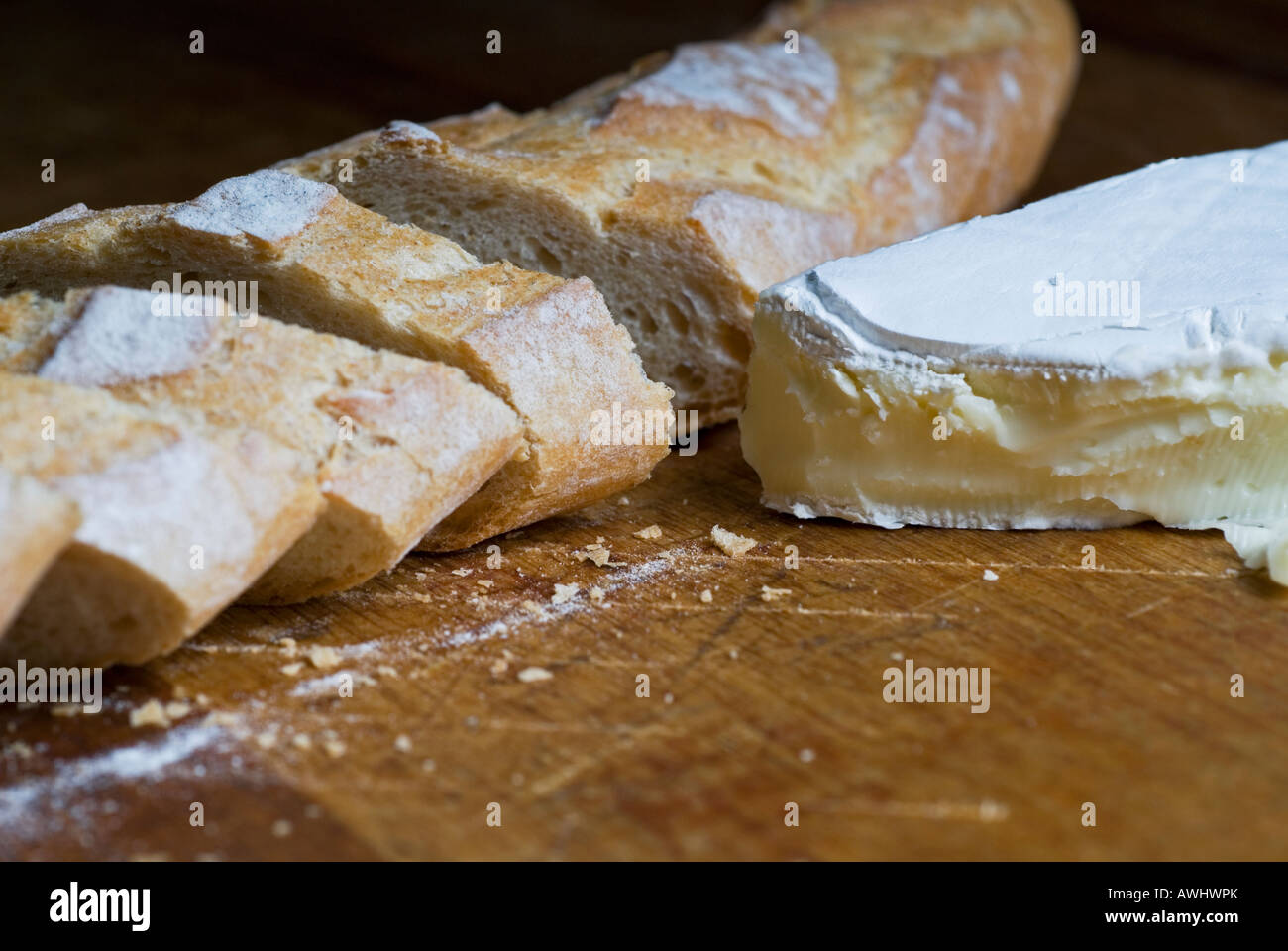 Stock photo of sliced French stick with a lump of Brie cheese Stock ...