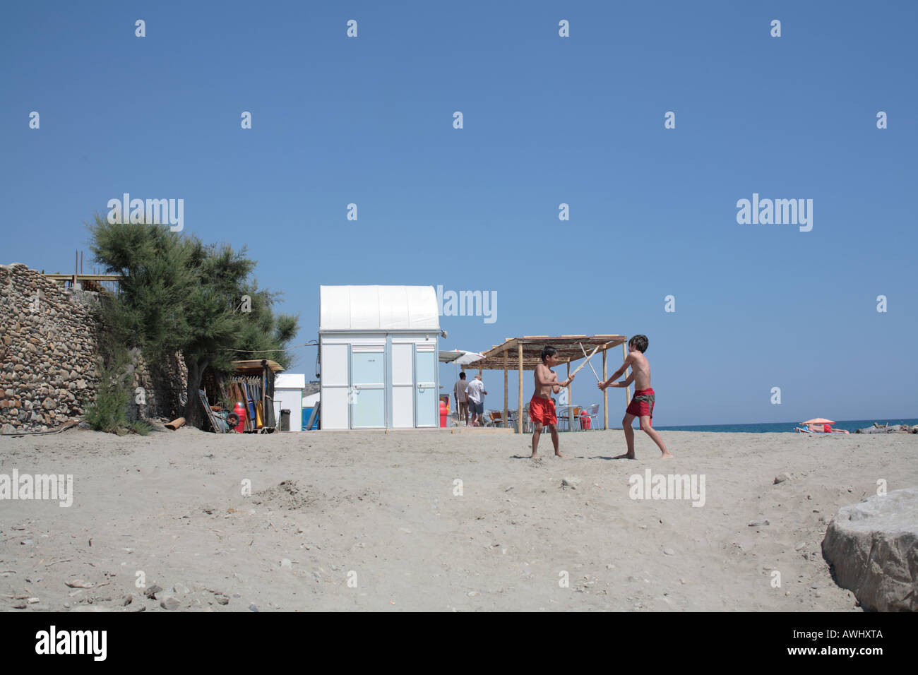 two boys playing knight on beach 8-12 years Stock Photo - Alamy