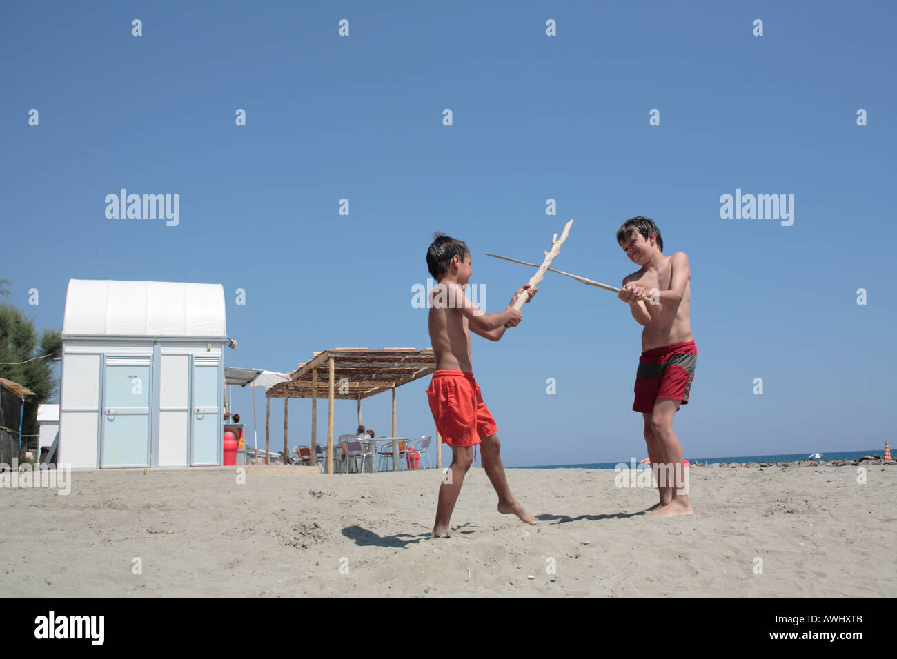 two boys playing knight on beach 8-12 years Stock Photo - Alamy