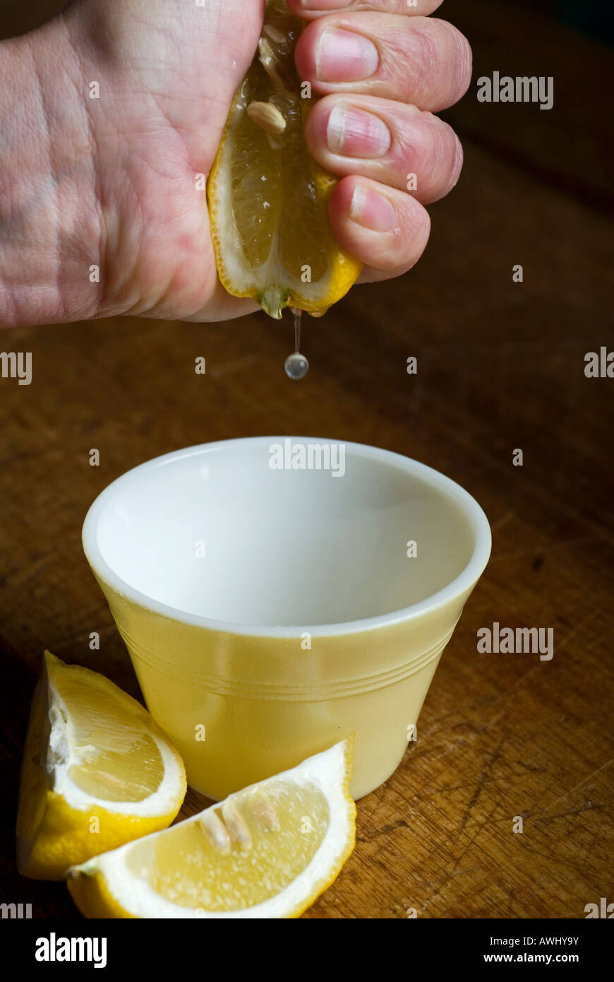 Stock photo of a womans hand squeezing a fresh lemon into a cup Stock ...