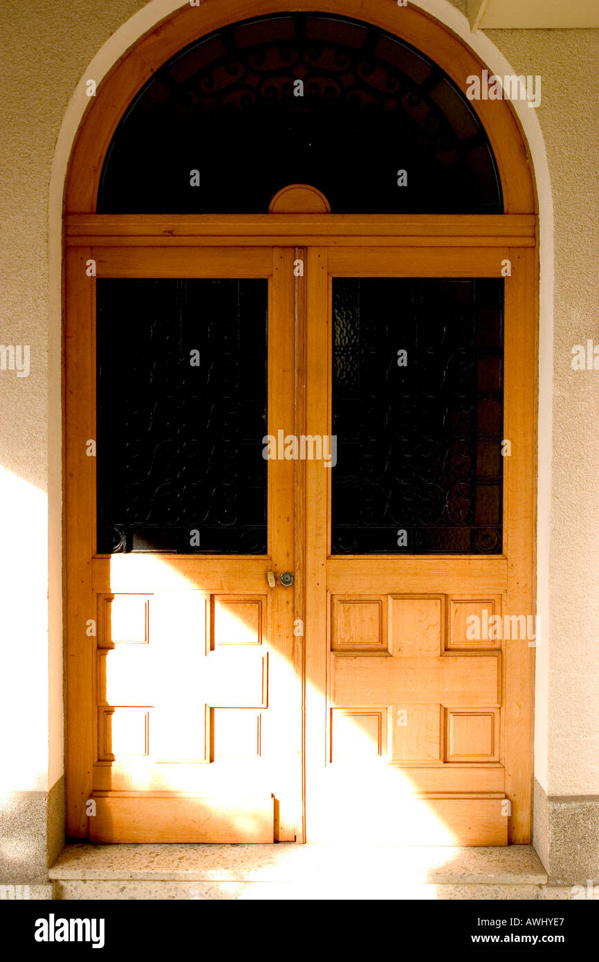 glass door of new modern church with cross with catholic religious sign ...