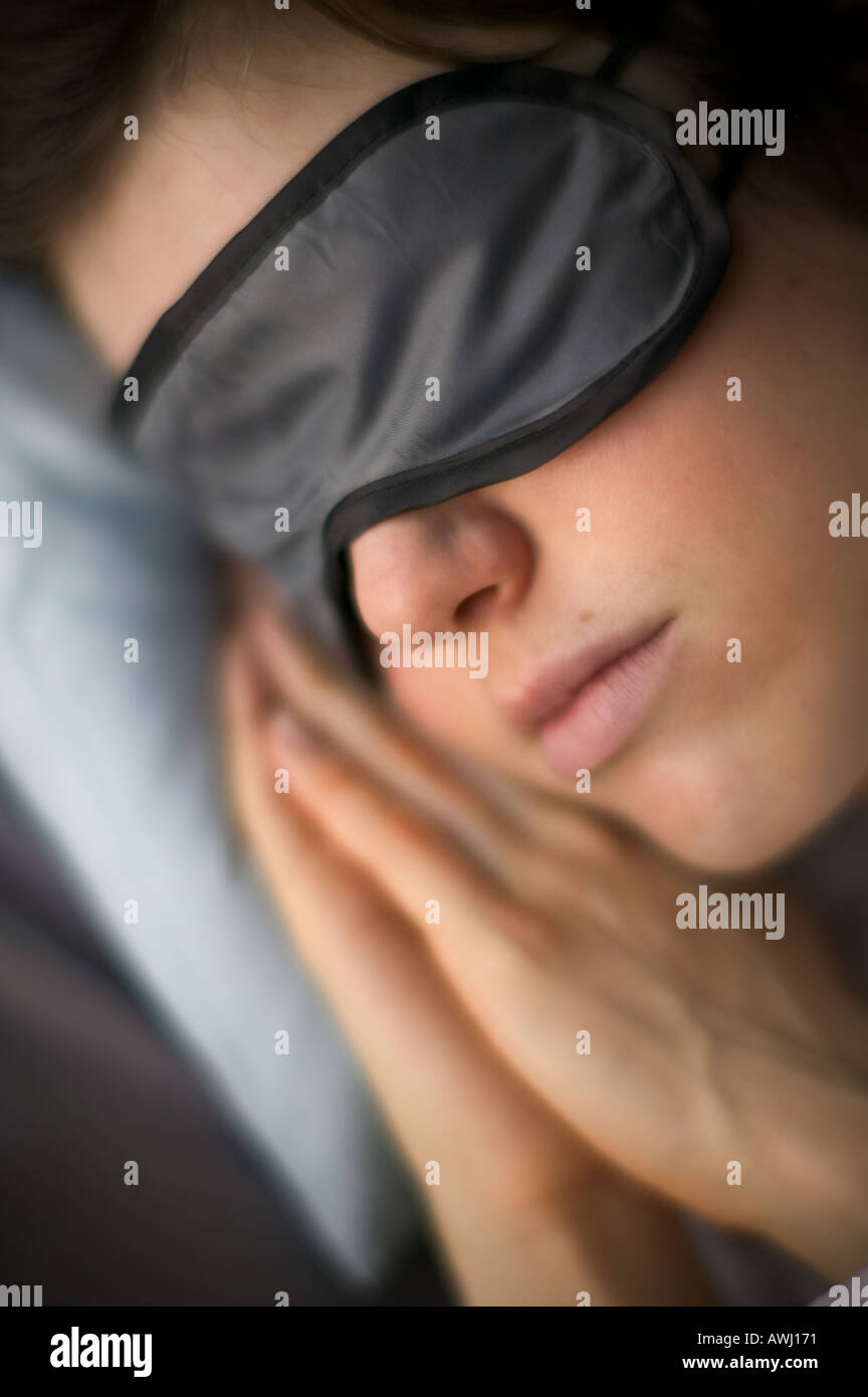woman sleeping with eyemask and hands under her face Stock Photo - Alamy