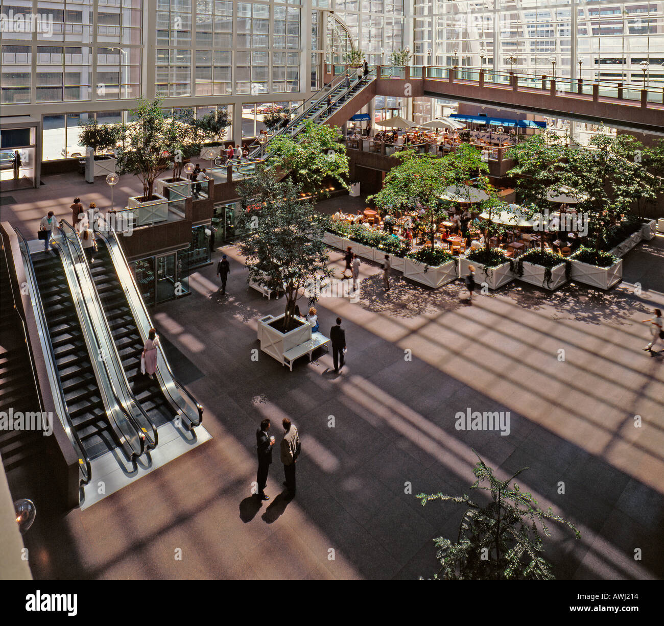Glass atrium of high rise office building with business people Stock ...